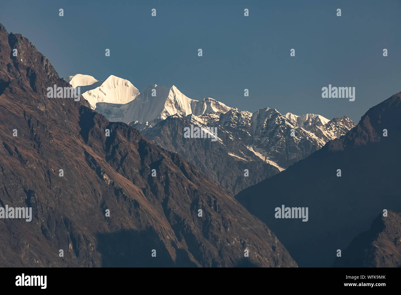 Mount Trishul Himalayan snow peaks with barren mountain ranges at ...