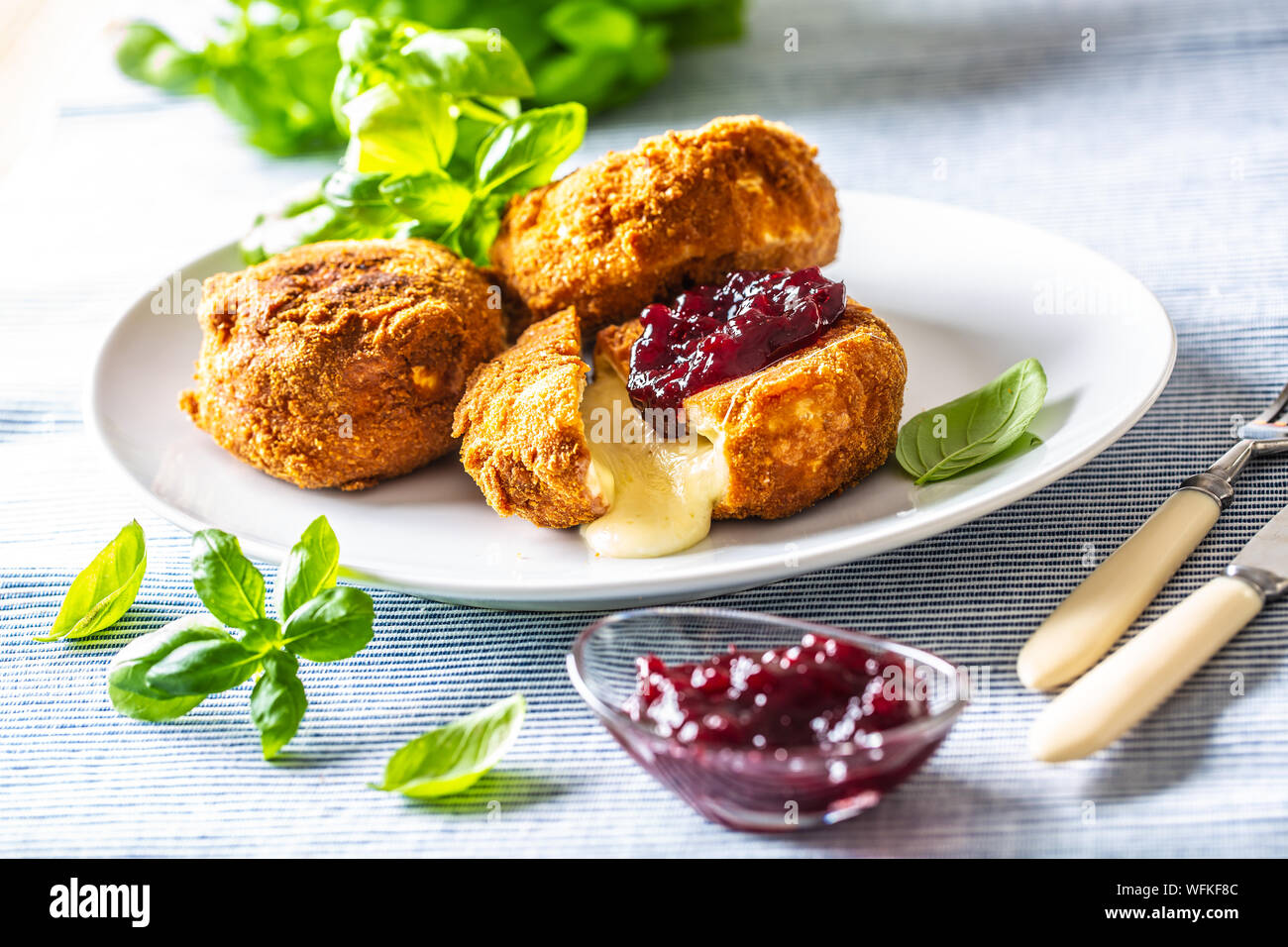 Fried camembert or brie cheese with cranberry jam and basil Stock Photo ...