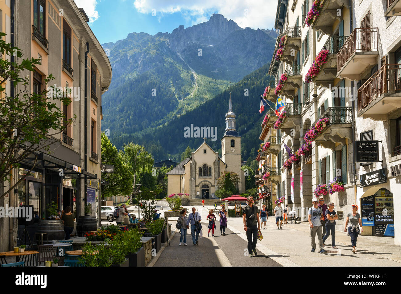 Street view with tourists, the church of Saint-Michel and Le Brévent ...
