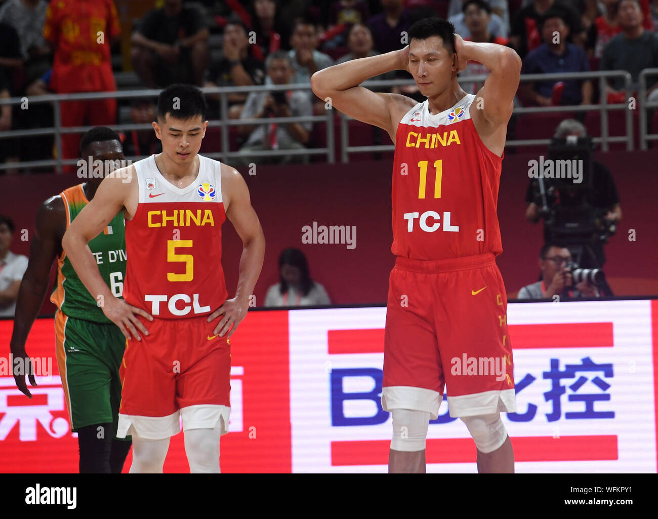 Beijing, China. 31st Aug, 2019. Yi Jianlian (R) of China reacts during ...