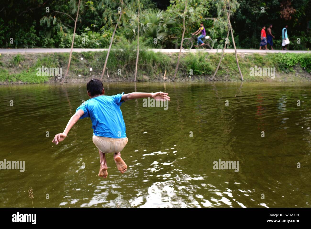 Boy jumping into pond hi-res stock photography and images - Alamy