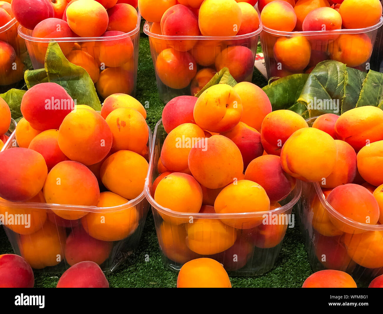 Nectarines in a transparent plastic box on a supermarket shelf. Fresh ...
