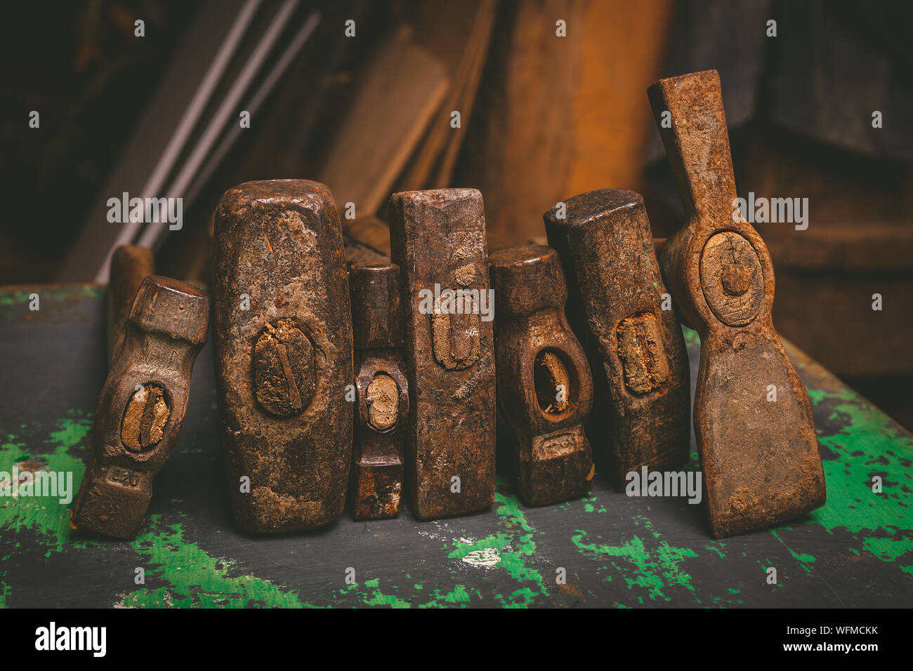 Set of old hammers and rusty nails. tools on old metal the surface ...