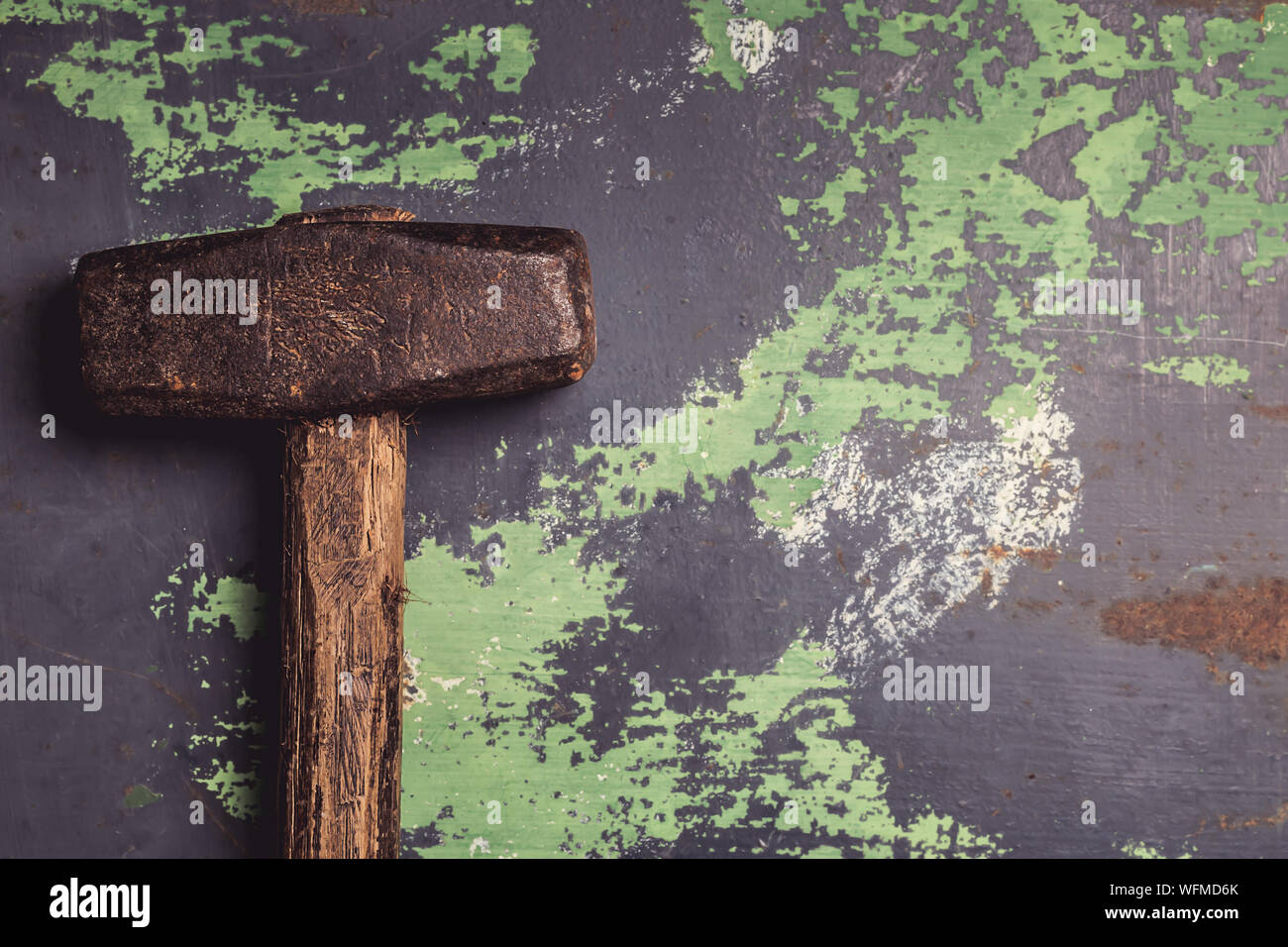 Old and scratched hammer on metal surface. Top view with copy space ...