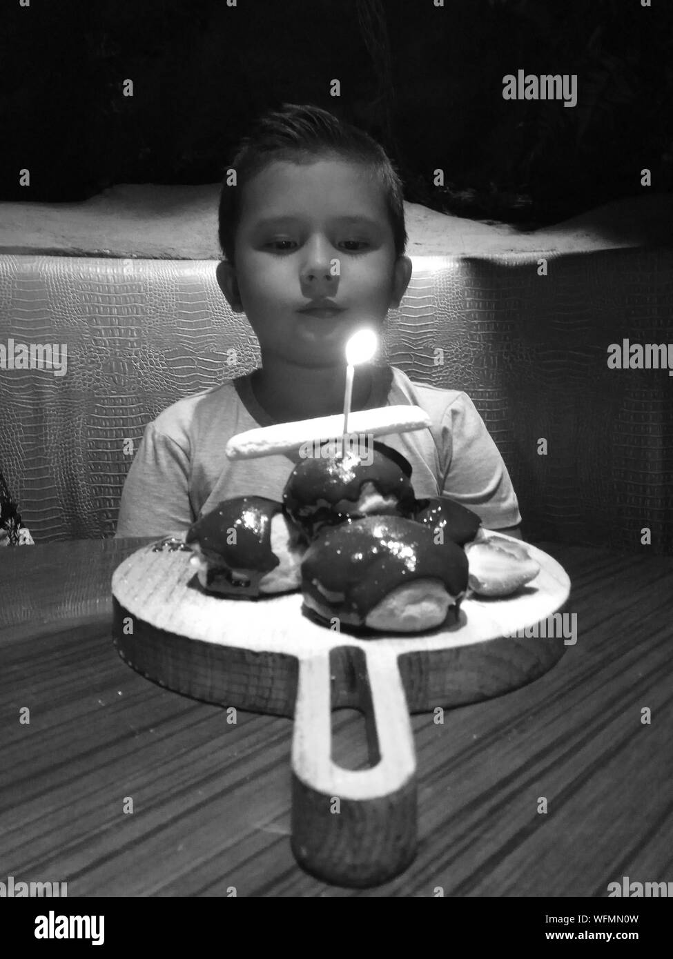 Boy sitting table Black and White Stock Photos & Images - Alamy