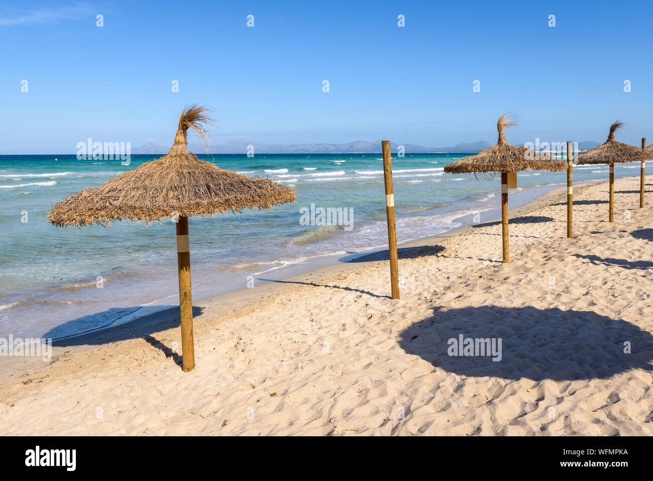 Umbrellas at the Playa de Muro beach in Mallorca, Spain Stock Photo - Alamy