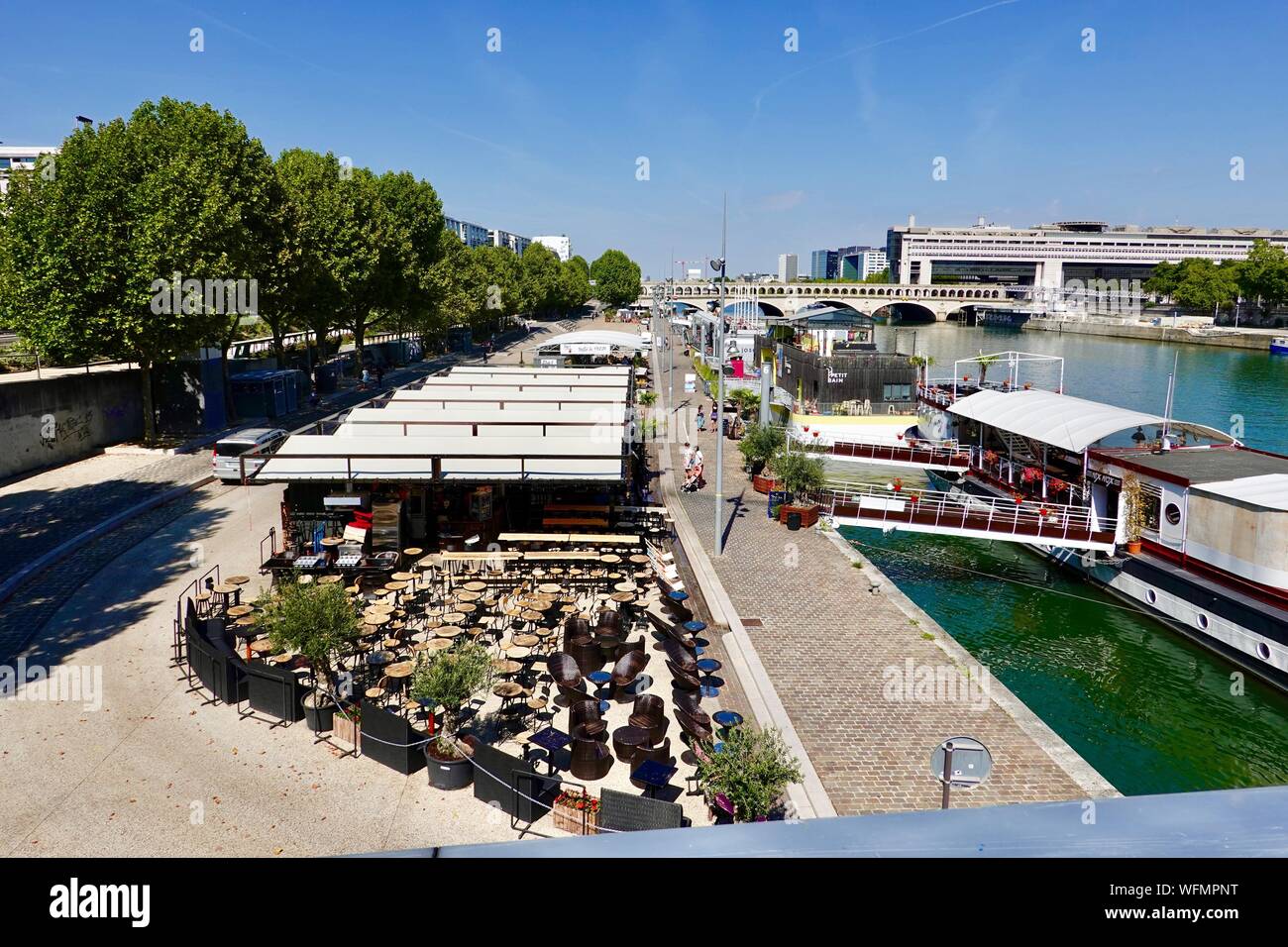 Floating bars and restaurants with outdoor seating areas along the ...