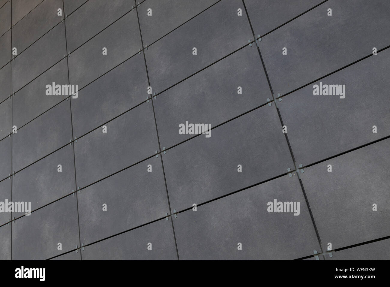 Diagonal view of smooth gray rectangular tile on wall, for background ...