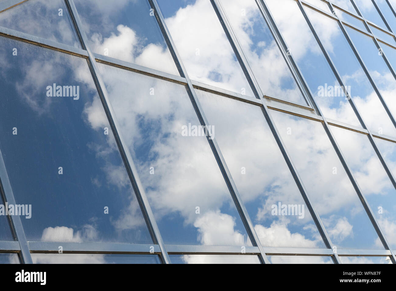 Angular view of glass building view with sky reflection Stock Photo - Alamy
