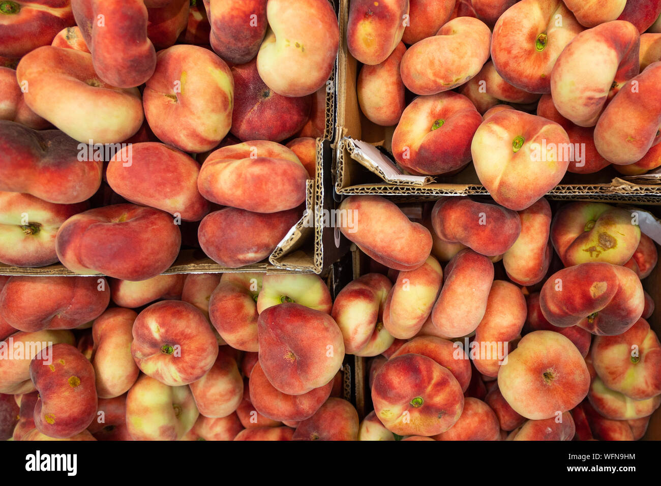 Fig peach, flat peaches at farmer's market or grocery shelves. Top view ...