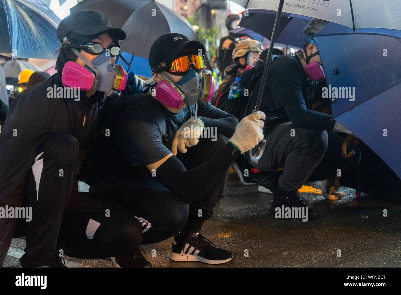Protesters wearing gas masks to protect themselves from police tear gas ...