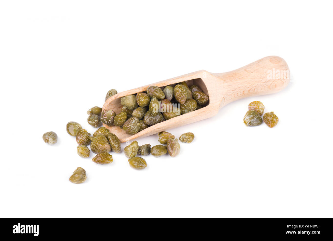 Capers in wooden spoon isolated on white background. Pickled capers ...