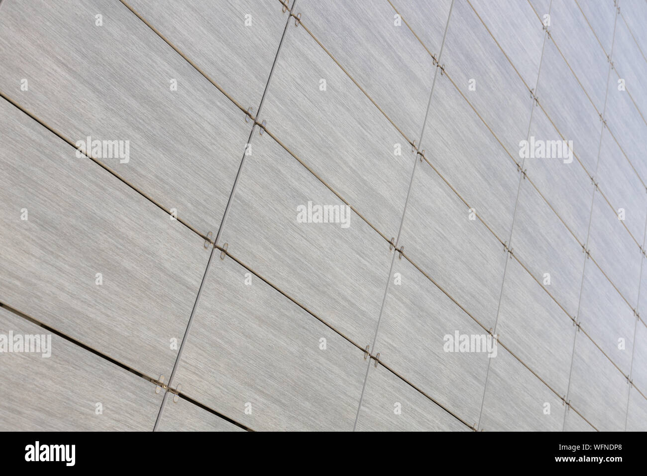 Textured pattern on gray rectangular tiles with dark space in between ...