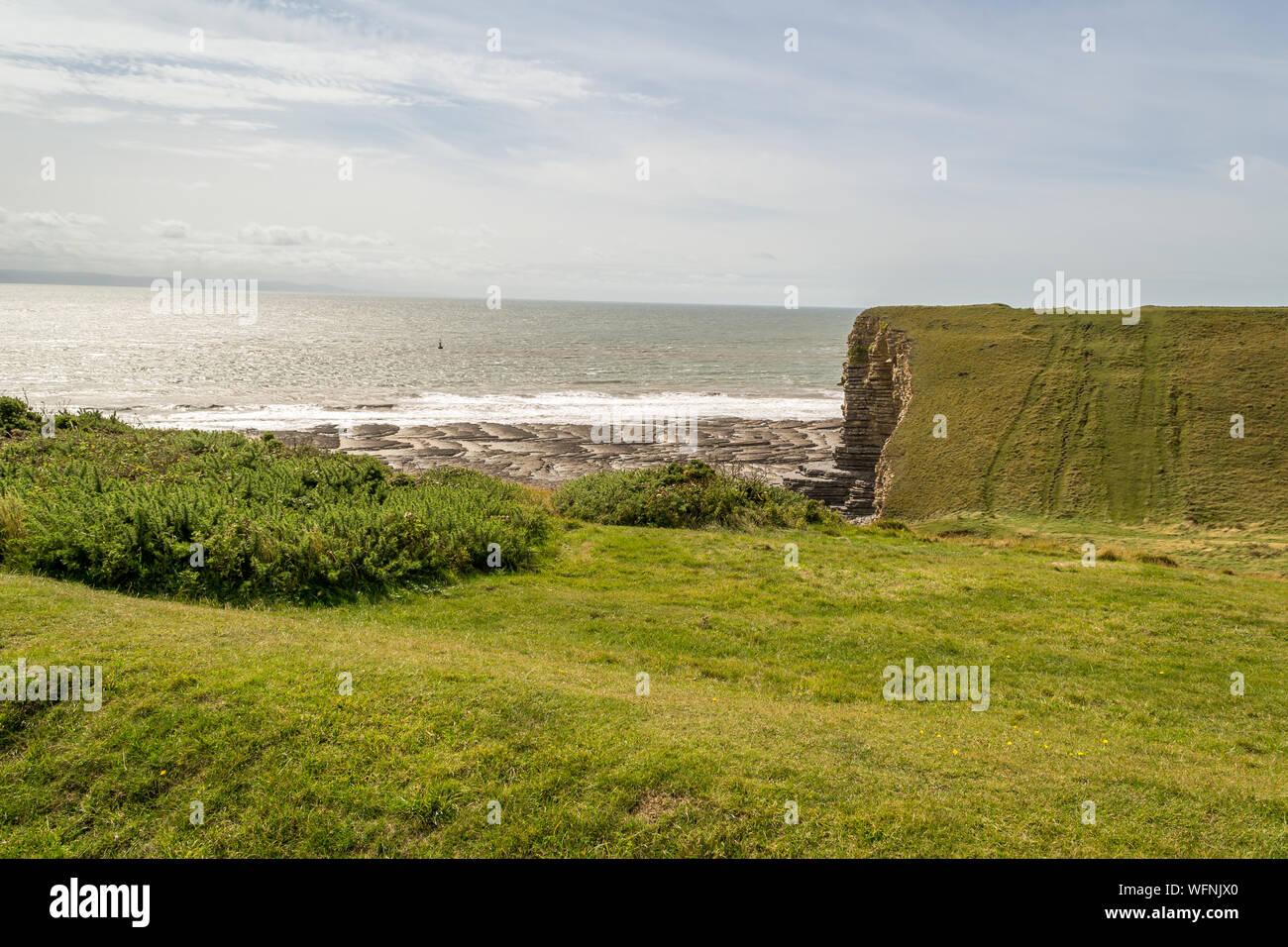 Coast with beach and monuments, Wales Stock Photo - Alamy