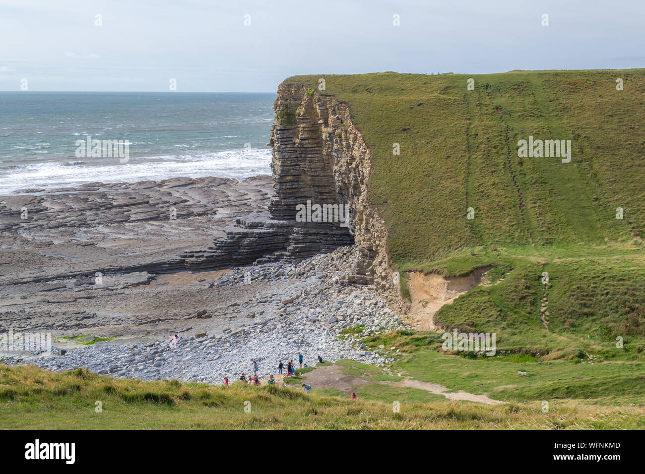 Coast with beach and monuments, Wales Stock Photo - Alamy