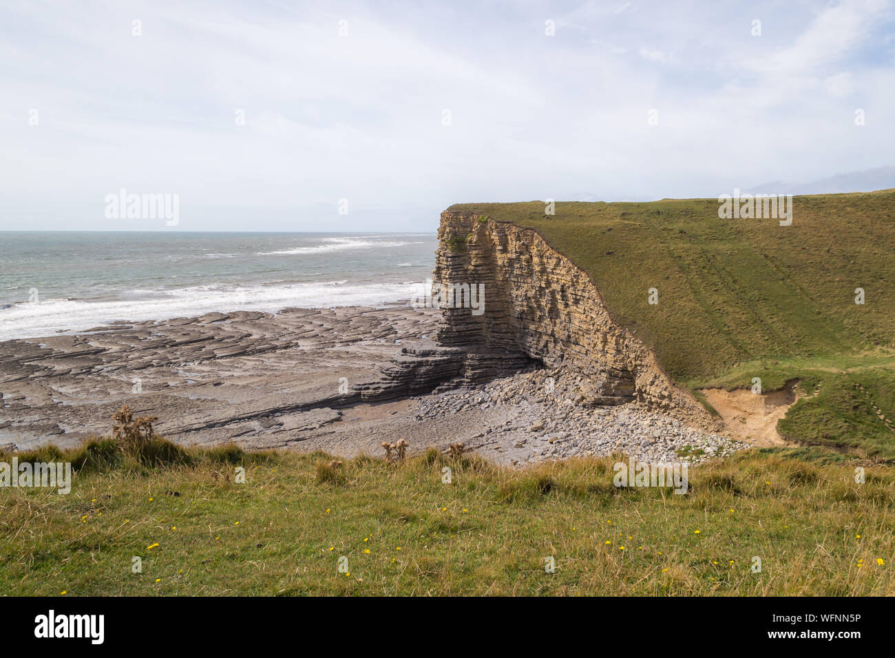 Coast with beach and monuments, Wales Stock Photo - Alamy
