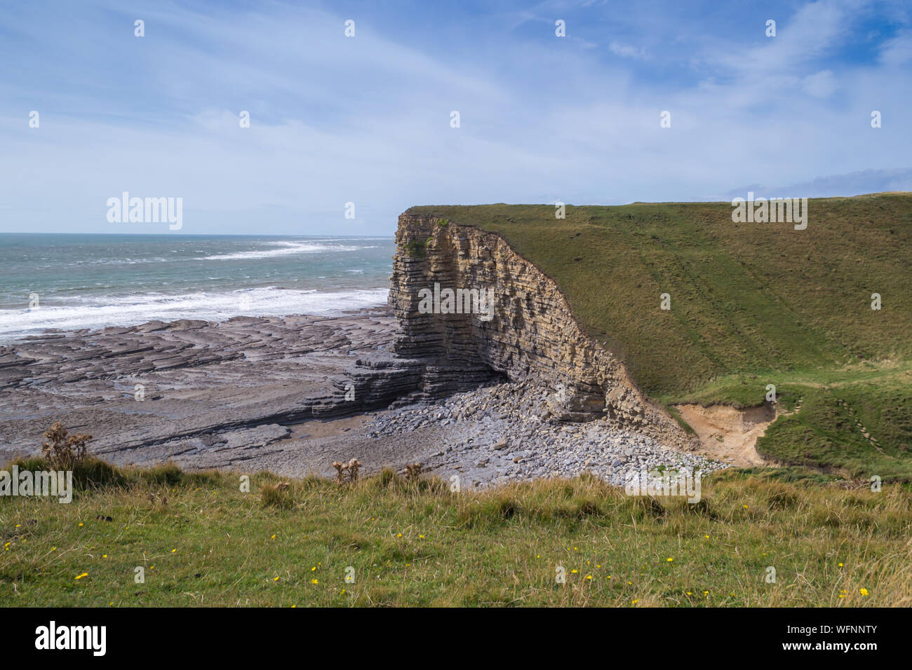 Coast with beach and monuments, Wales Stock Photo - Alamy