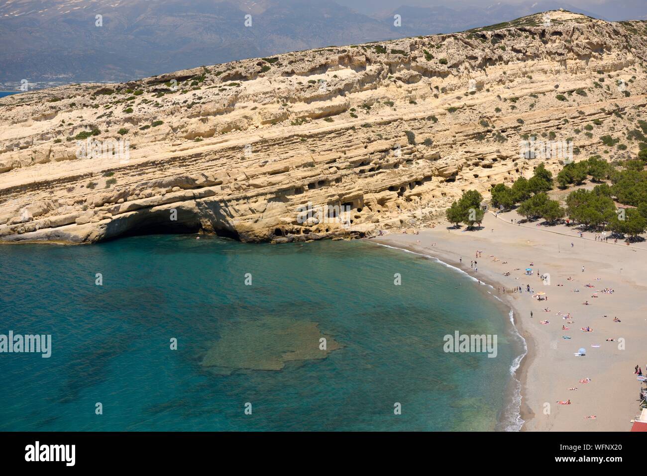 Greece, Crete, Matala, Matala Bay, beach and caves seen from the south ...