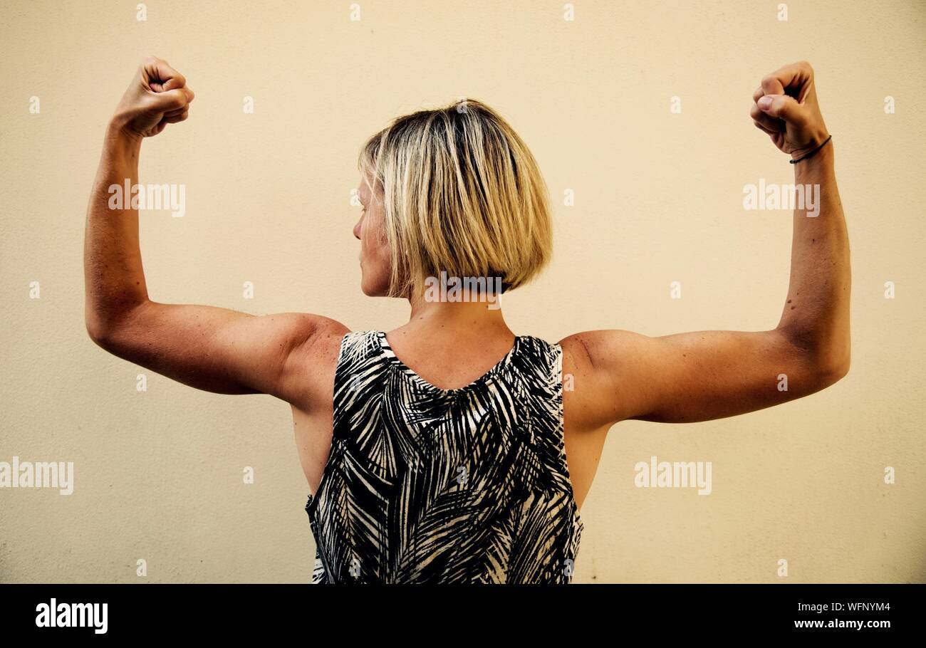 Rear view muscular woman flexing hi-res stock photography and images ...