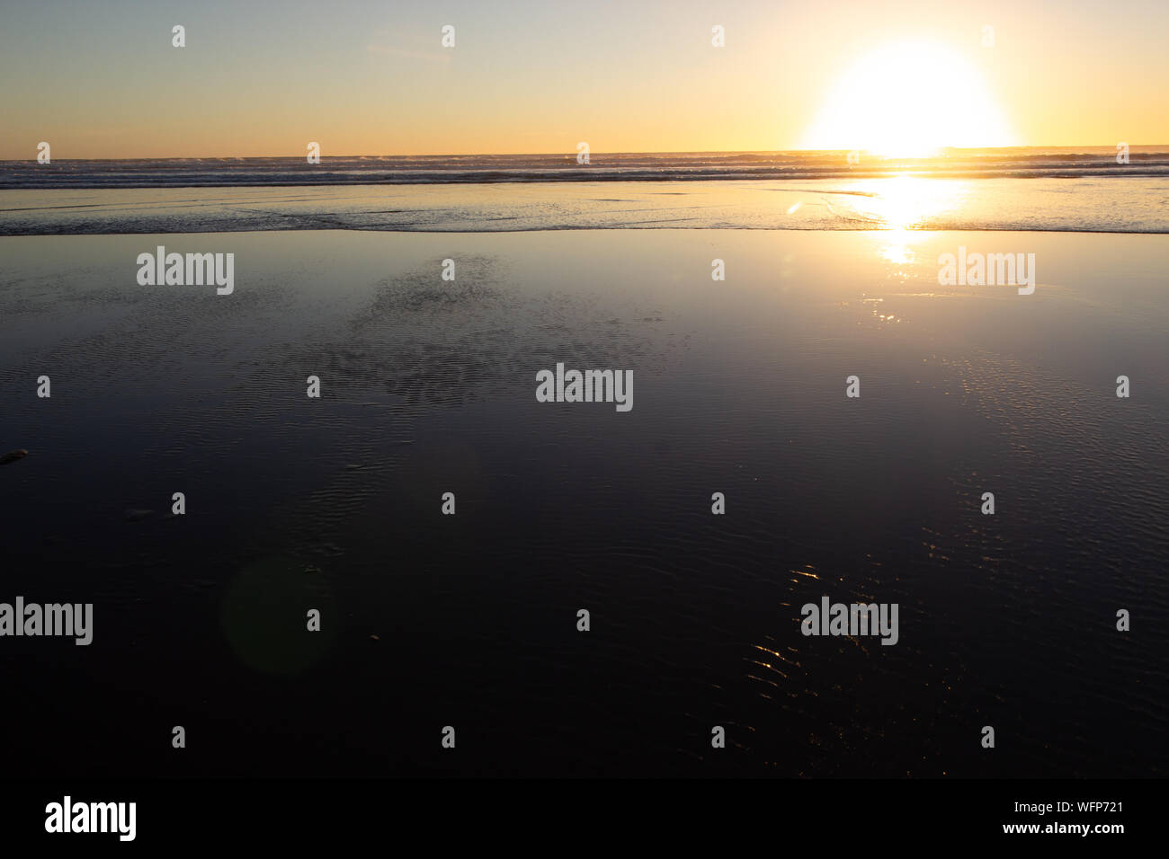 sunset at Piha beach, North Island, New Zealand Stock Photo - Alamy