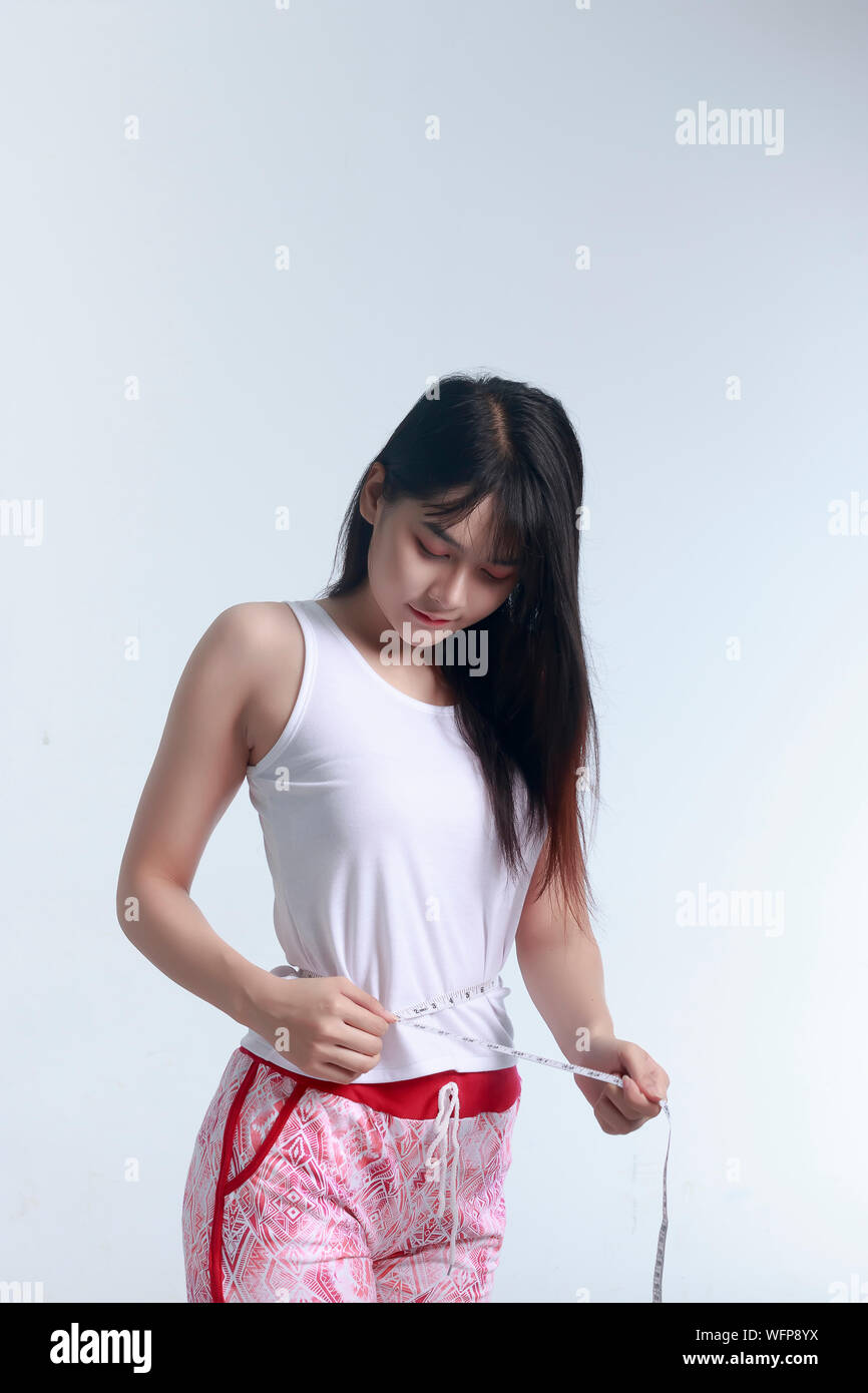 Beautiful woman measuring her waist hi-res stock photography and images ...