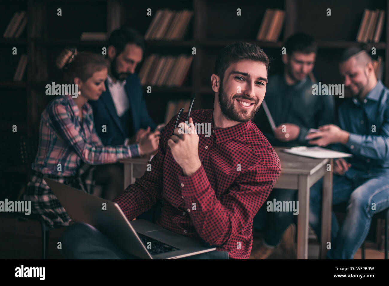 horizontal photo - successful employee of the company with laptop on ...