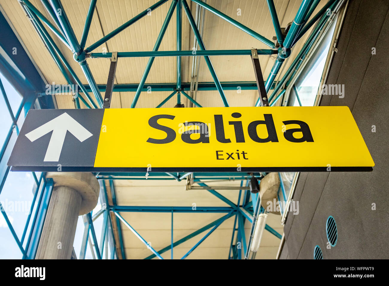 Exit sign written in Spanish and English in the Station Stock Photo - Alamy