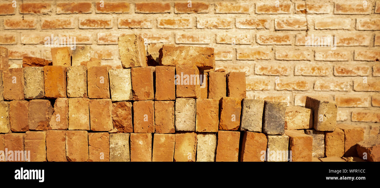 Brick Wall and Group of Bricks for a Construction Stock Photo - Alamy