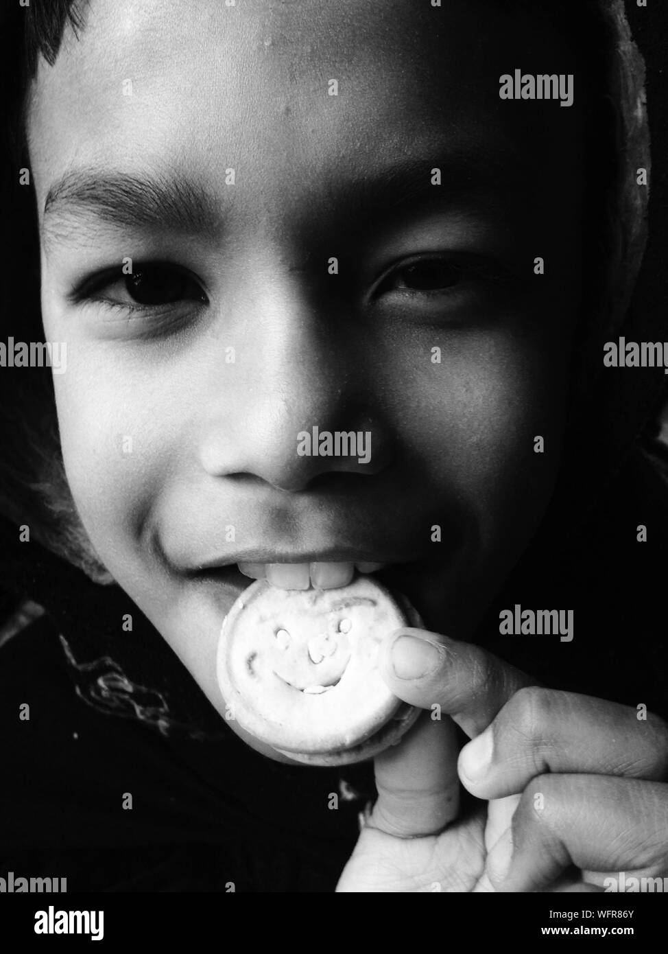 Indian boy eating biscuit hi-res stock photography and images - Alamy