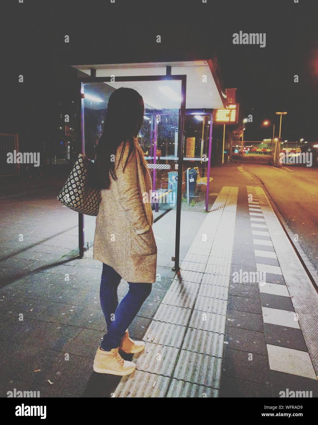 Woman waiting for bus night hi-res stock photography and images - Alamy