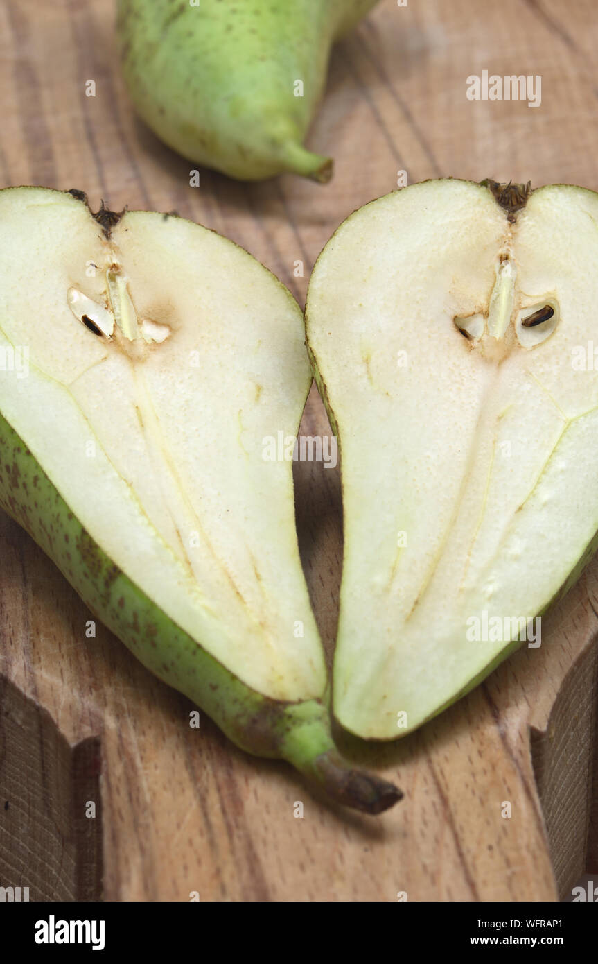pear split in two on wood board for backgrounds and textures Stock ...