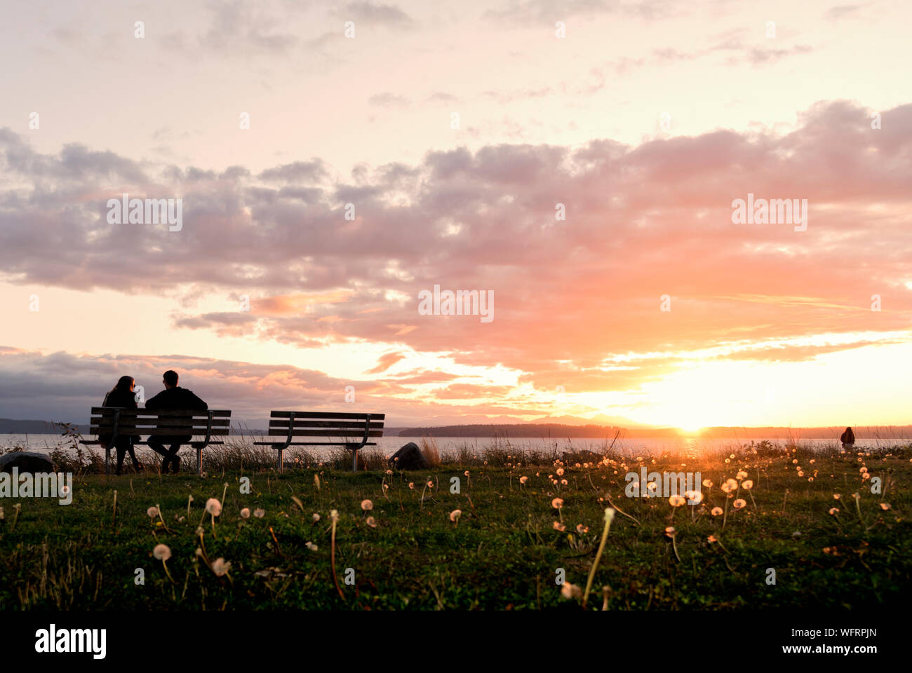 Couple Sitting On Bench At Sunset High Resolution Stock Photography and ...