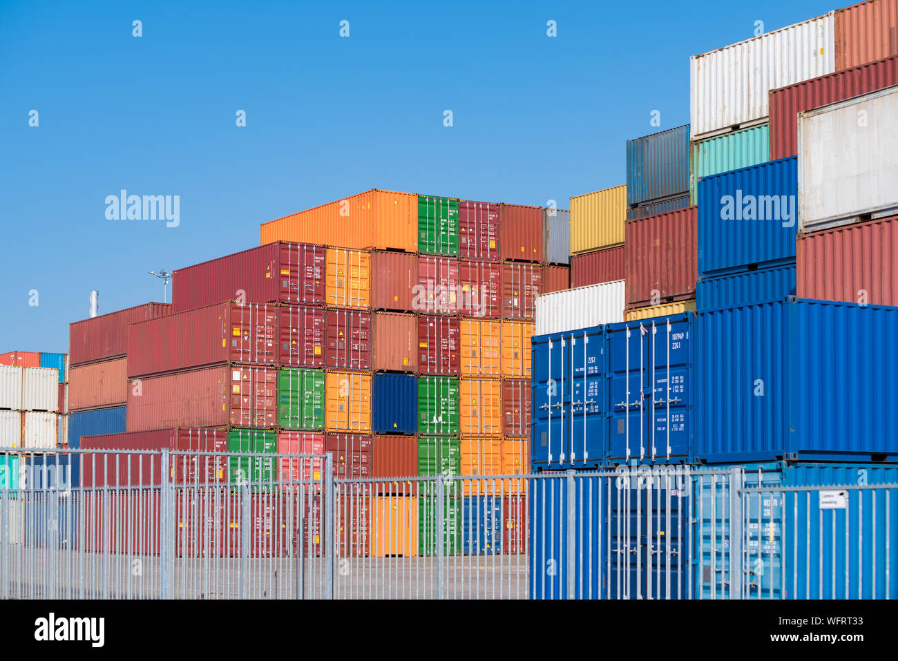 lots of piled up containers at a container terminal in the netherlands ...