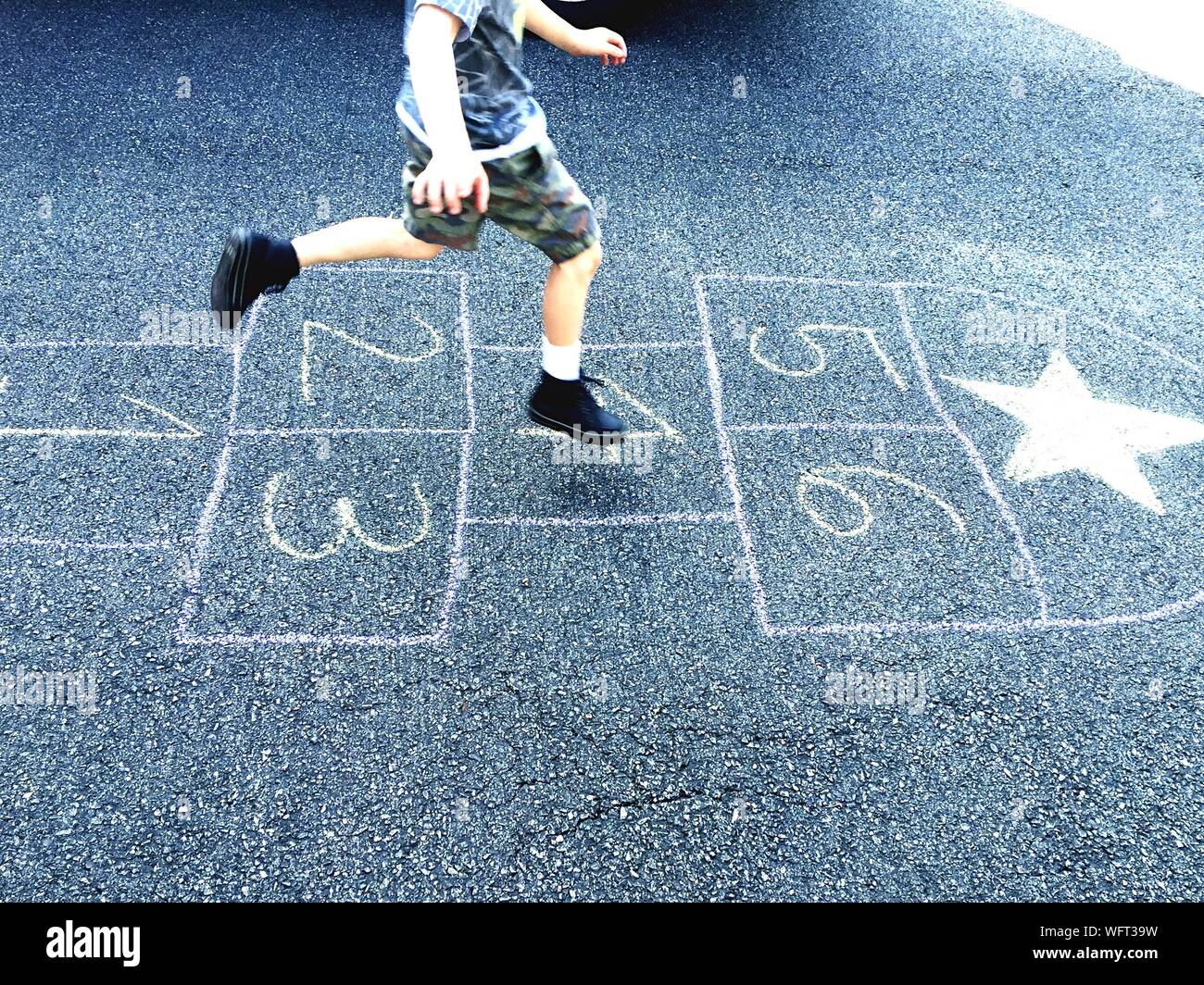 Boy playing hopscotch hi-res stock photography and images - Alamy
