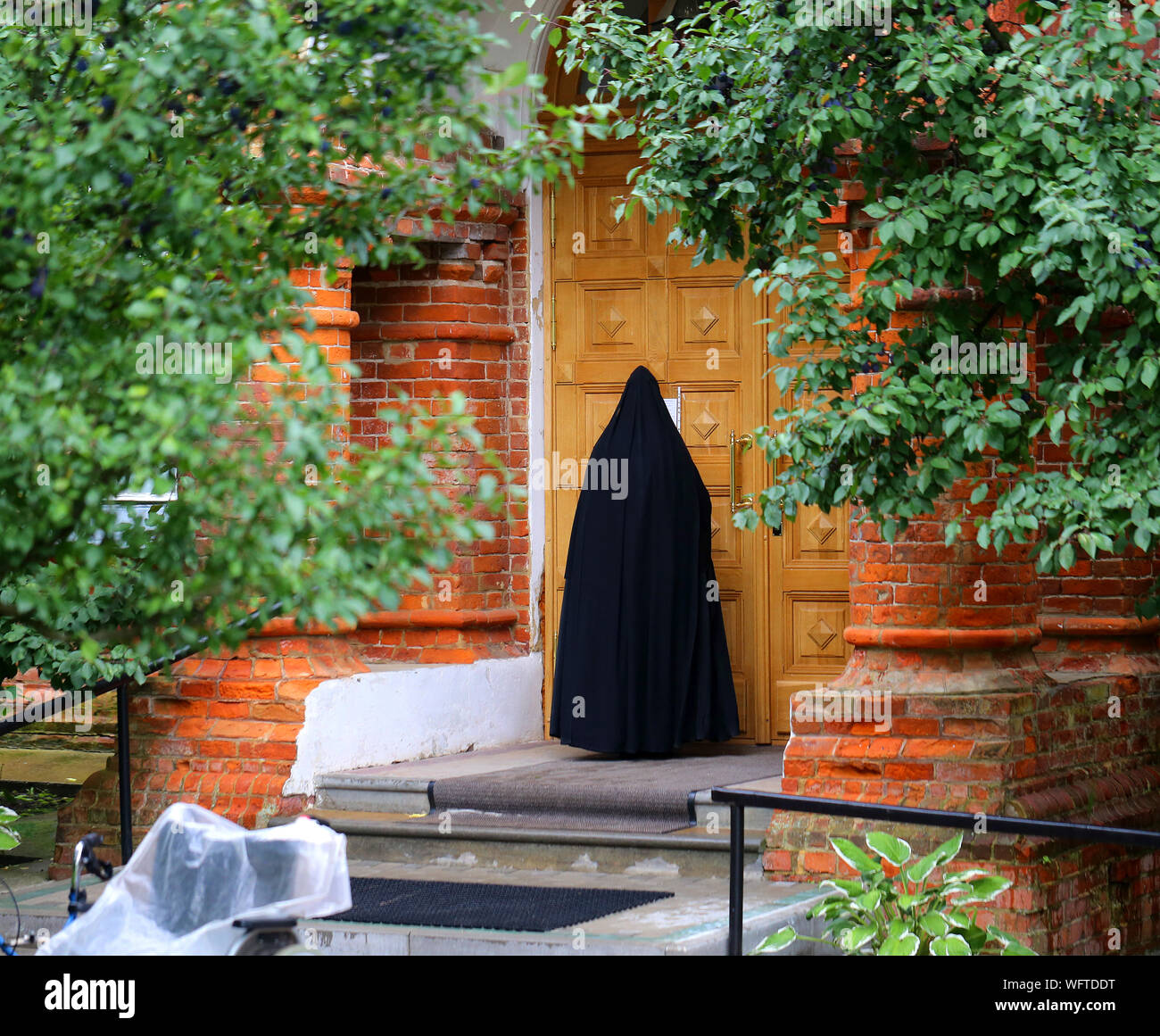 A nun enters the door of the Orthodox Church Stock Photo - Alamy