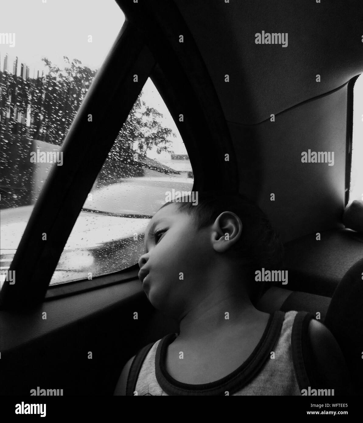 Boy looking through car window Black and White Stock Photos & Images ...