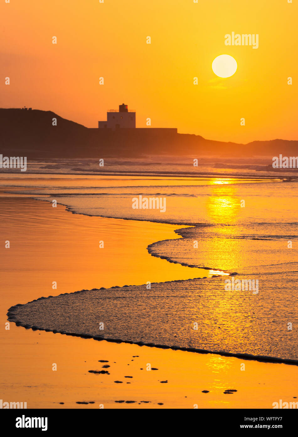 Sunset at Bamburgh lighthouse, Northumberland, UK Stock Photo - Alamy