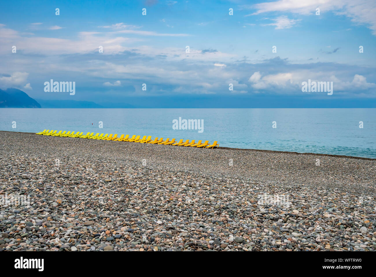 beautiful view of the stony beach in kvariati, Adjara. deck chairs on ...