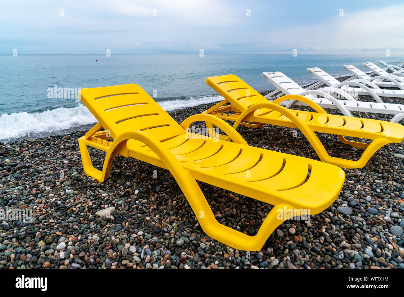 beautiful view of the stony beach in kvariati, Adjara. deck chairs on ...