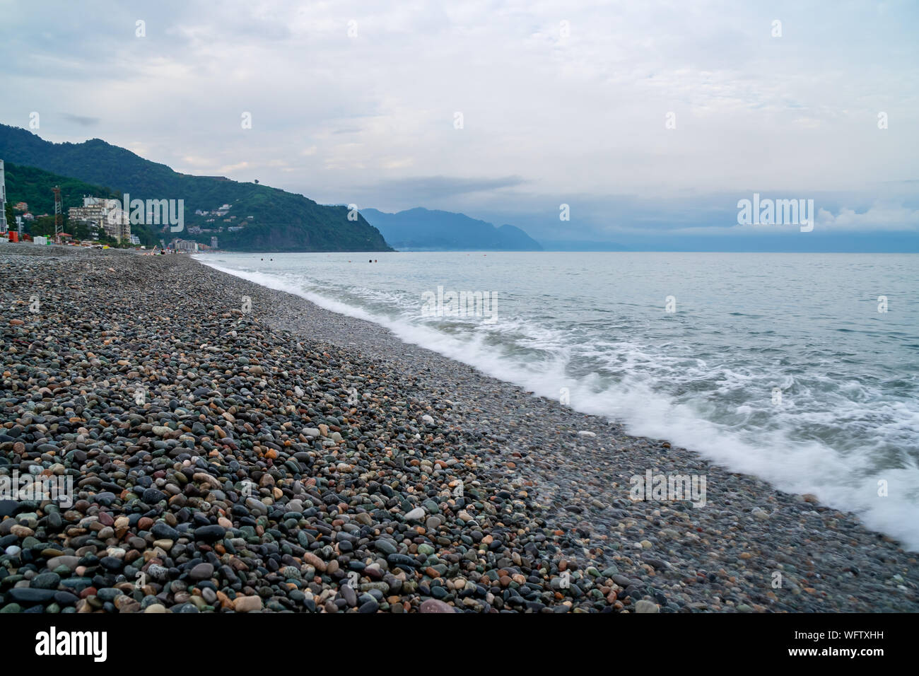beautiful view of the stony beach in kvariati, Adjara. deck chairs on ...