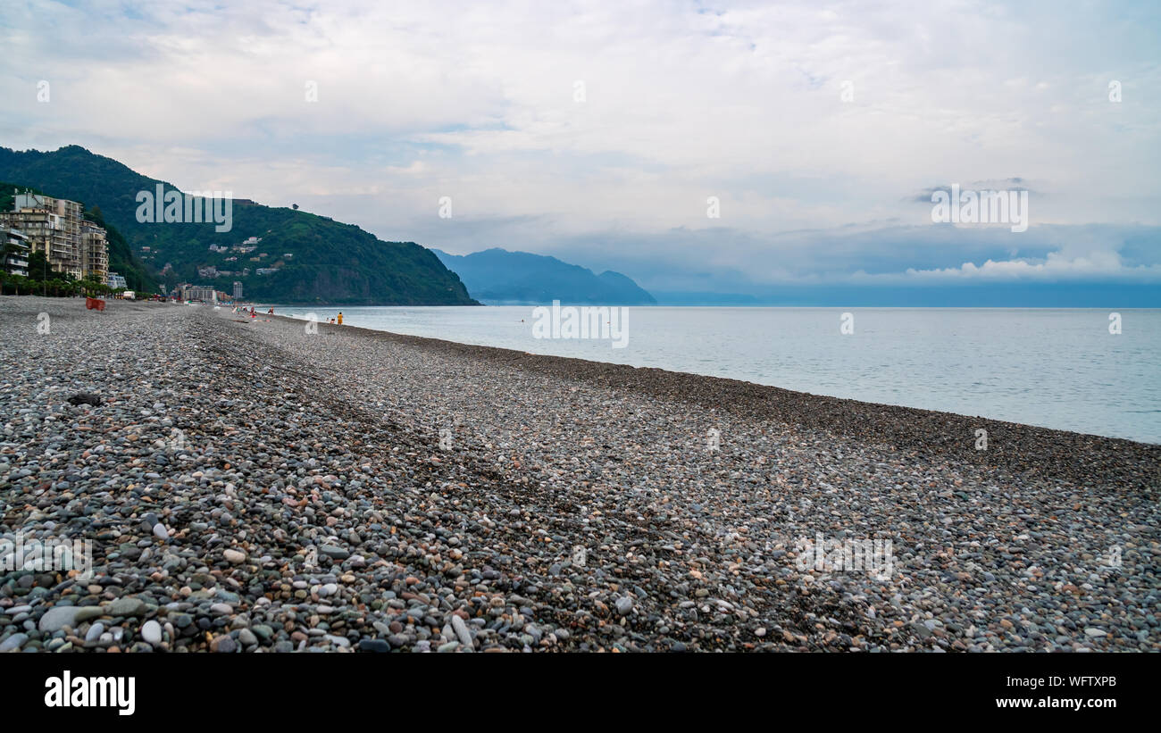 beautiful view of the stony beach in kvariati, Adjara. deck chairs on ...