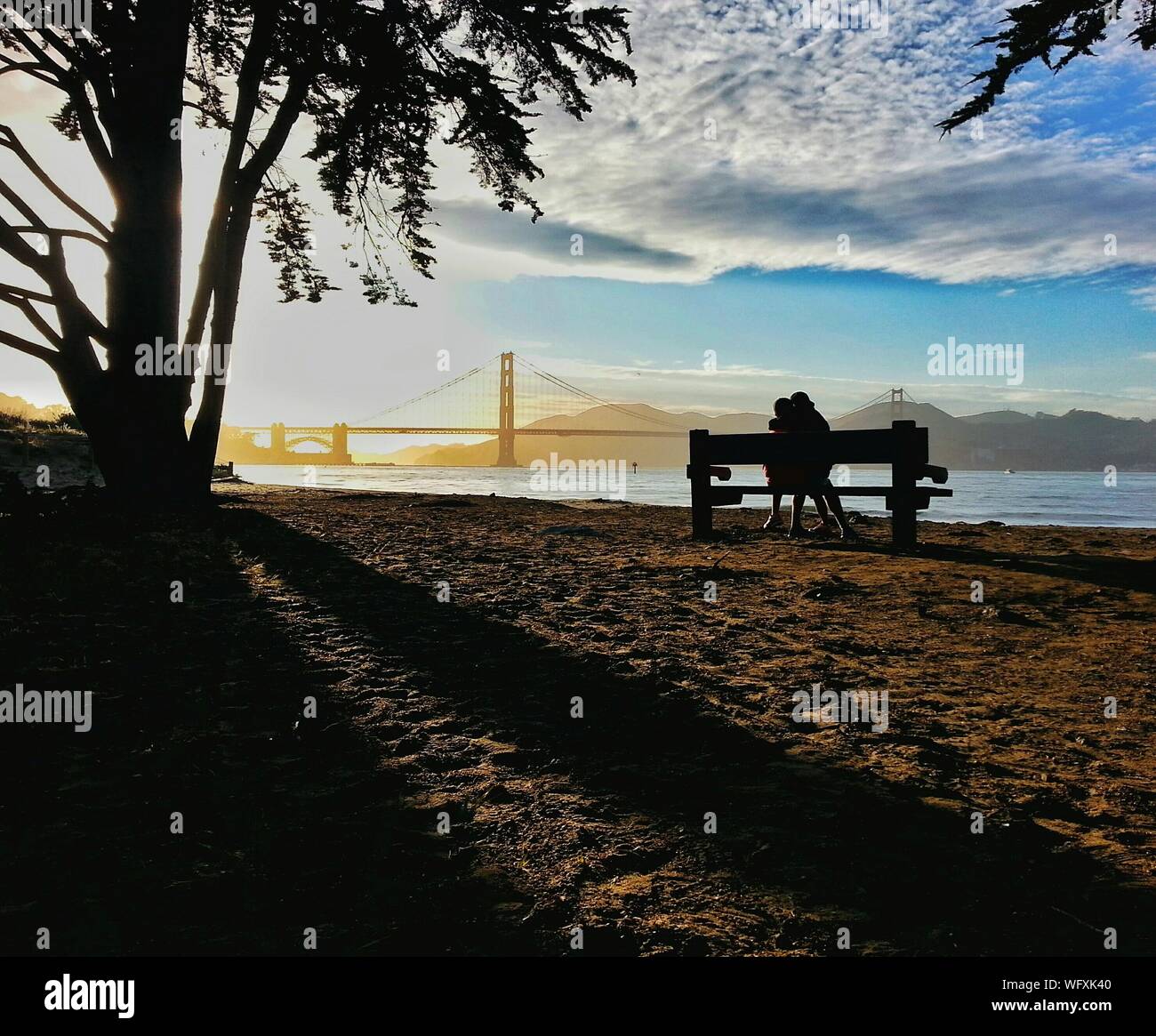 Silhouette Couple Sitting Bench Sunset Bench High Resolution Stock ...