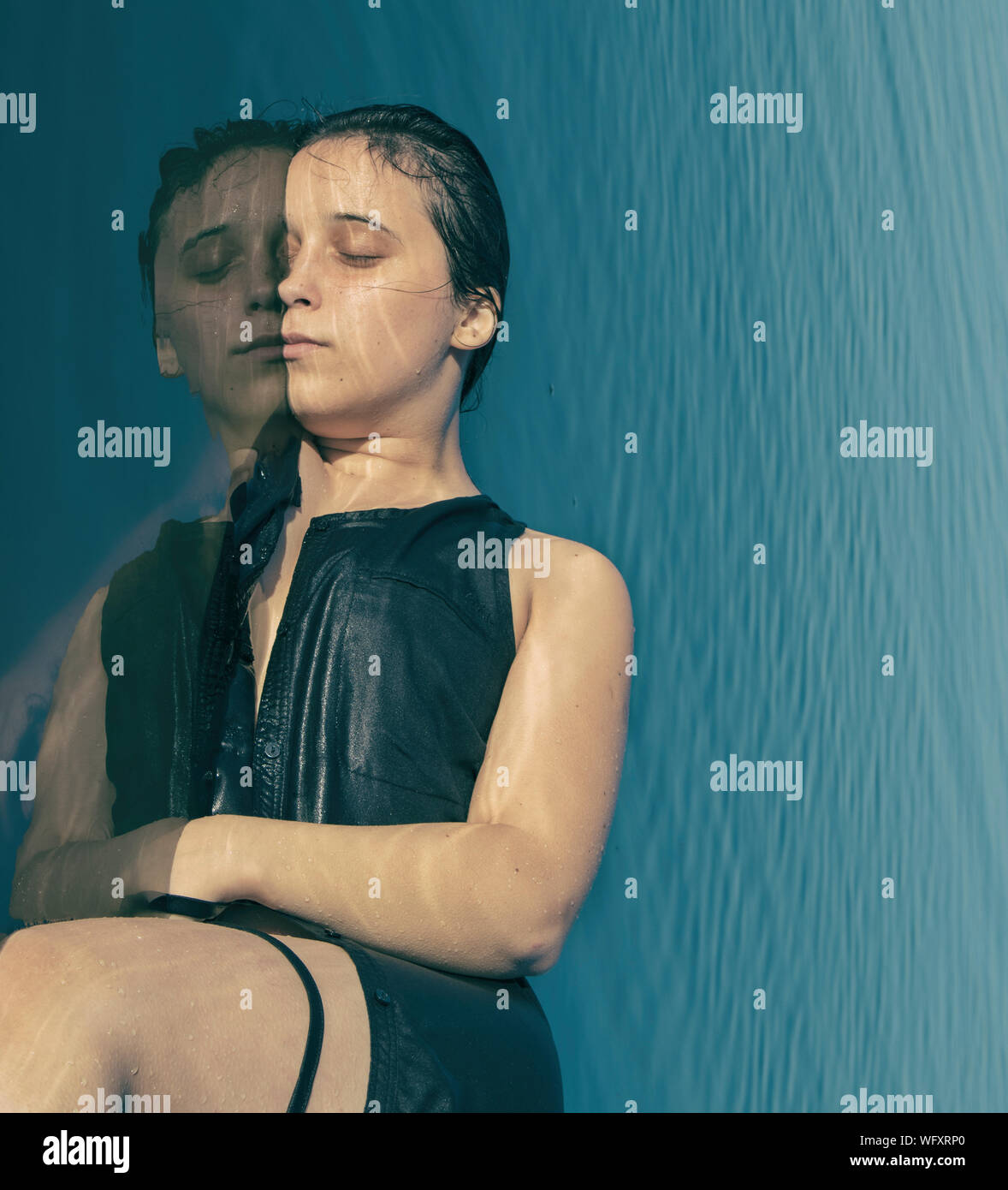 Young woman lying in water hi-res stock photography and images - Alamy