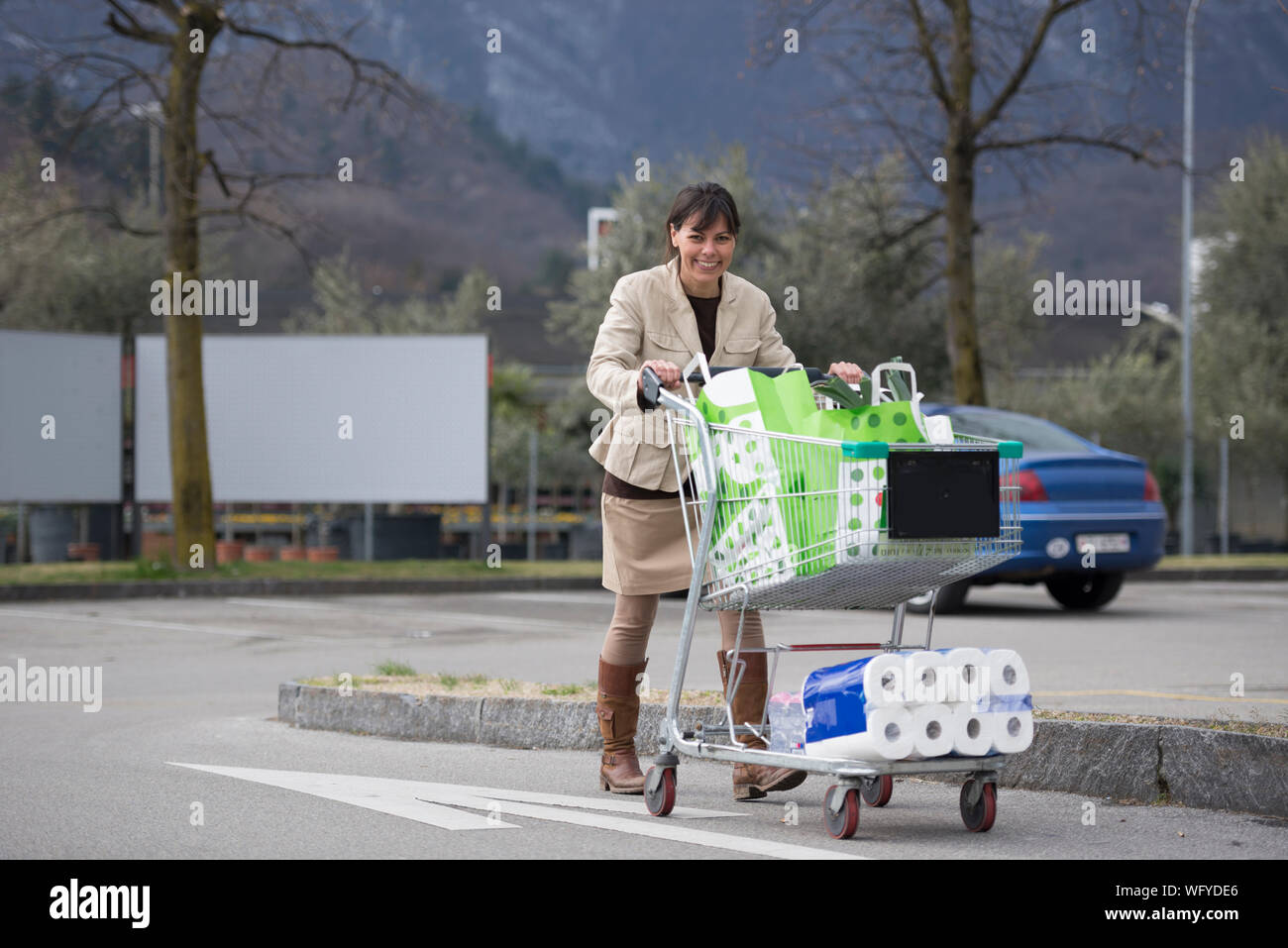 Woman pushing full shopping cart hi-res stock photography and images ...