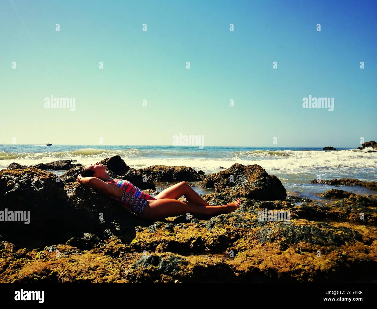 Woman Lying On Rocks High Resolution Stock Photography and Images - Alamy
