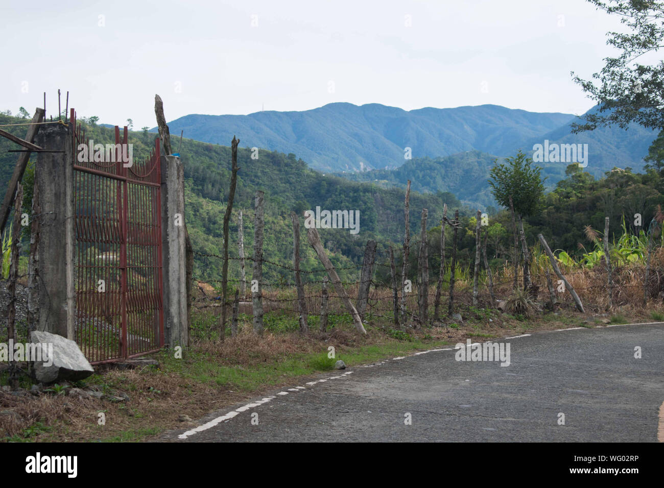 A gate and barb wires around an area. Restricted area along the road ...