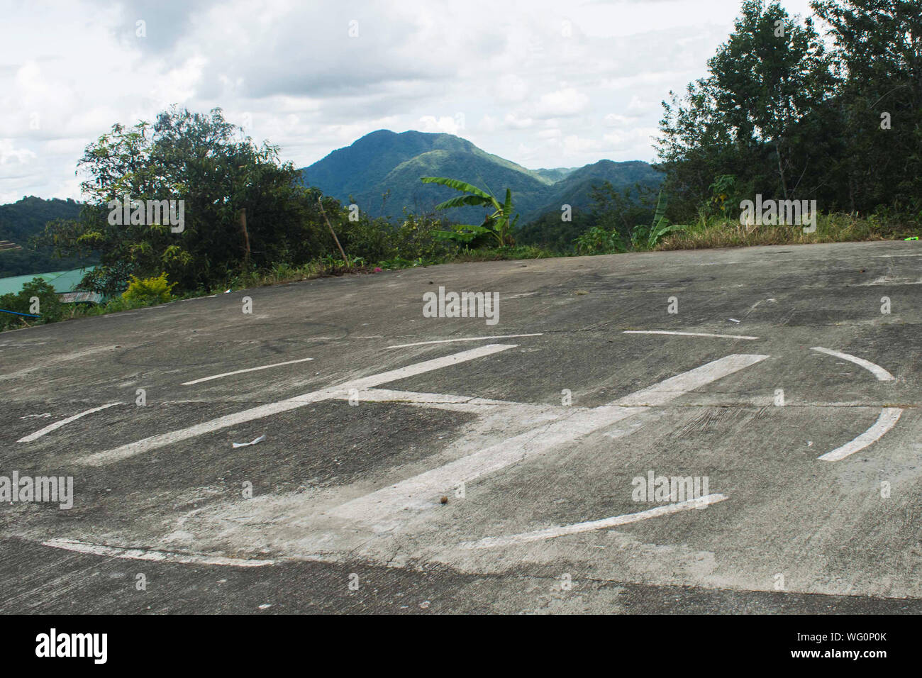 A small helipad with a huge letter H printed on its concrete pavement ...