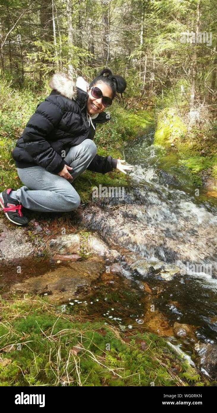 Young woman crouching at waterfall hi-res stock photography and images ...