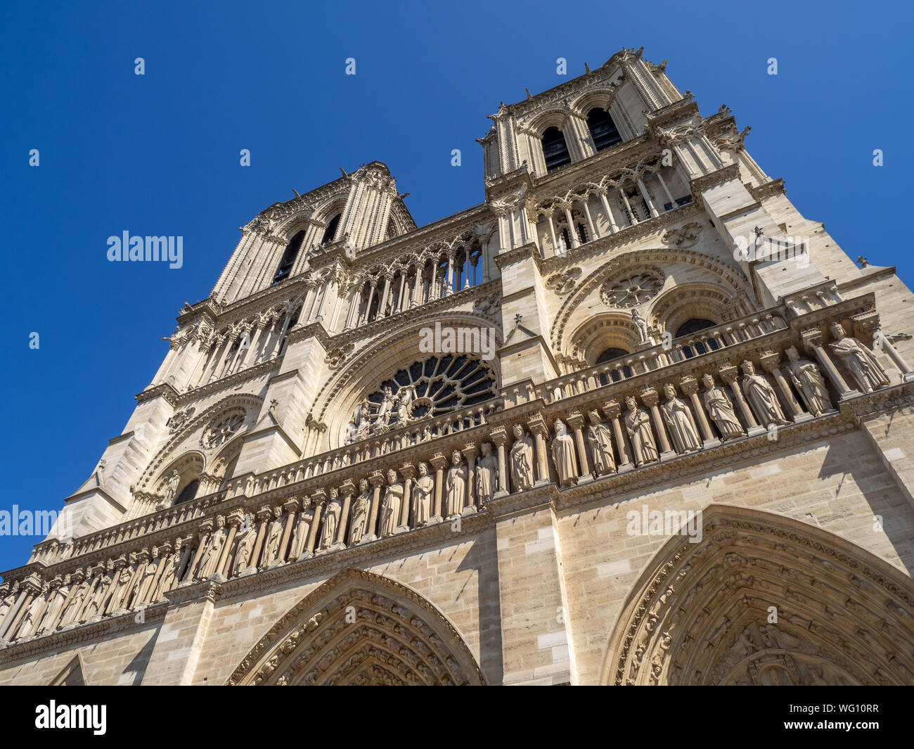 Looking up the exterior facade of Notre Dame de Paris cathedral in ...