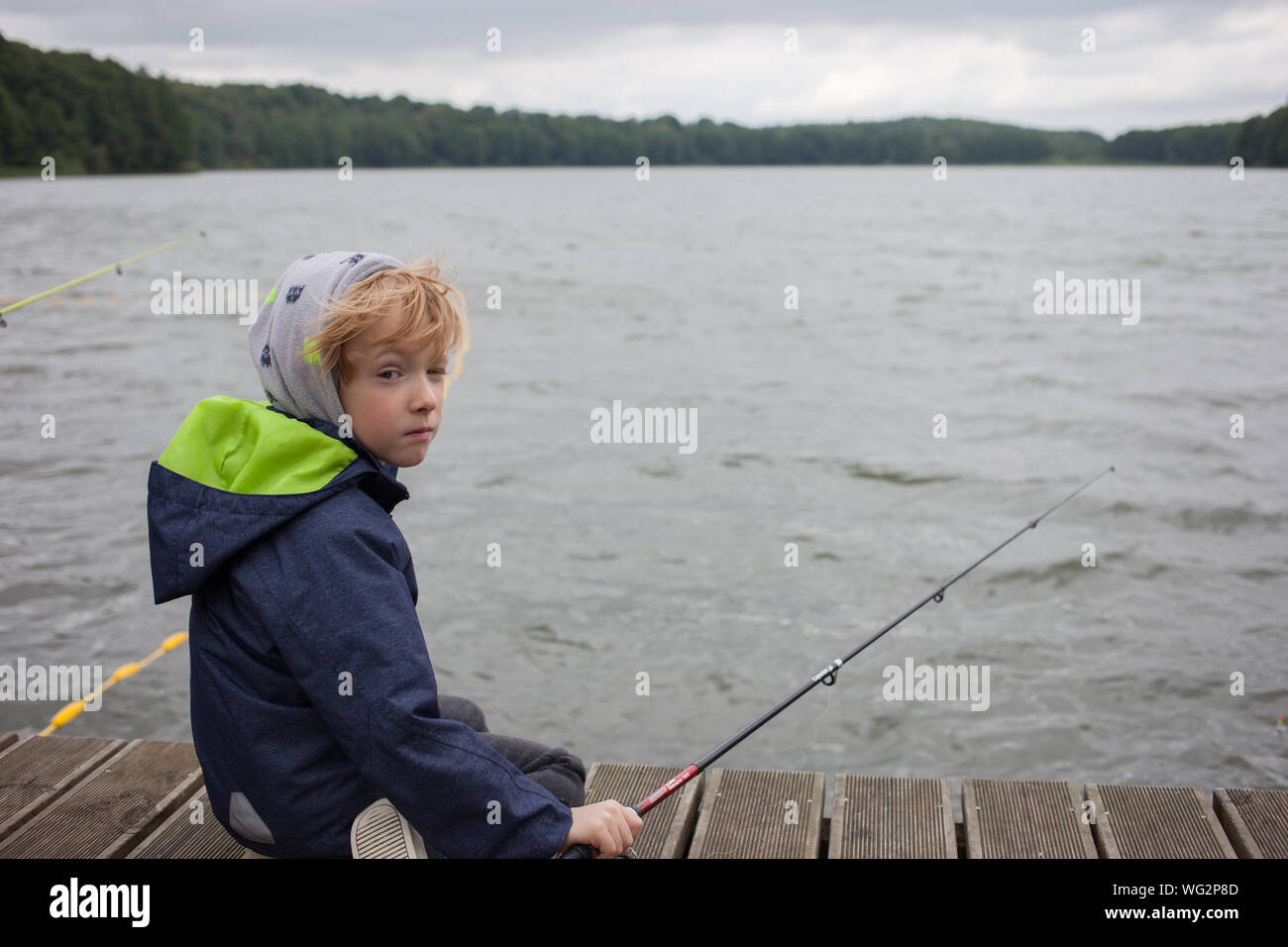 Boy on pier by lake hi-res stock photography and images - Alamy